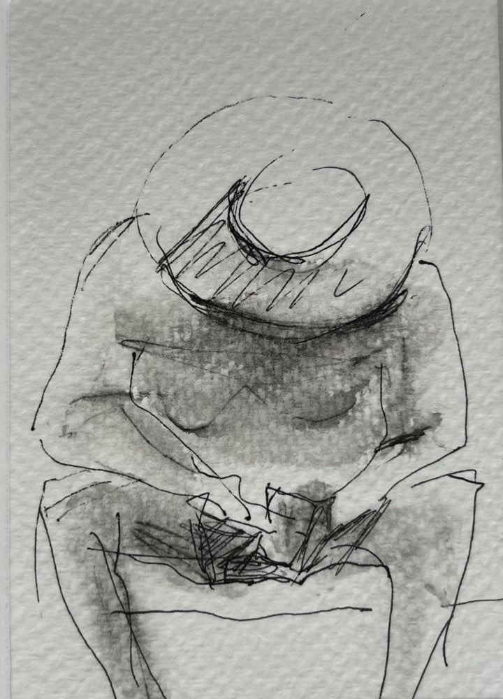 A man in a hat on the beach is busy with the phone | helloart